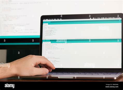 Testing Computer Program Theme Hand On Laptop In Blurred Screen With