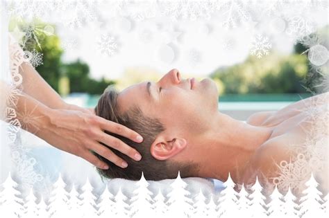 Premium Photo Peaceful Man Getting A Head Massage Poolside Against Fir Tree Forest And Snowflakes