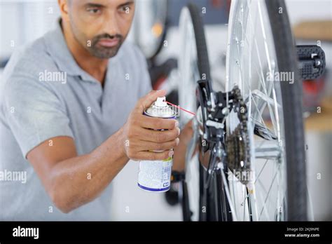 Man Adding Oil On Wheel Bike Stock Photo Alamy