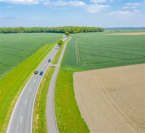 Aerial Photograph With The Drone Camera Of A Small Asphalted Country Road Leading Through Fields