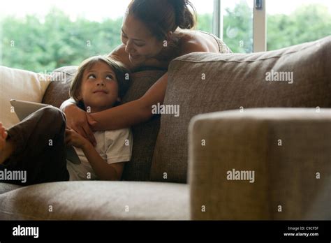 Mother Embracing Son On Sofa Stock Photo Alamy