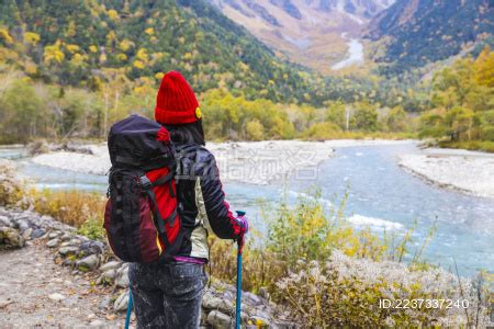 一个手拿登山杖站在山谷河边的女性徒步旅行者 站酷海洛 正版图片 视频 字体 音乐素材交易平台 站酷旗下品牌