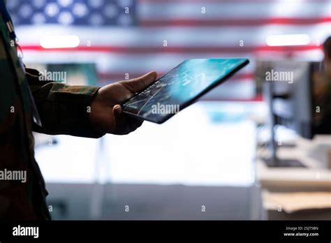 Professionals In Us Military Uniforms Operate Computers And Big Screen Working On Surveillance