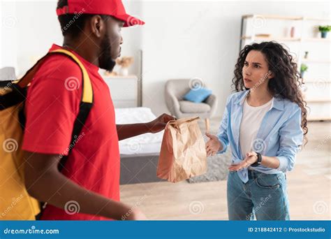 Confused Angry Lady Complaining About Bad Food Delivery Stock Photo