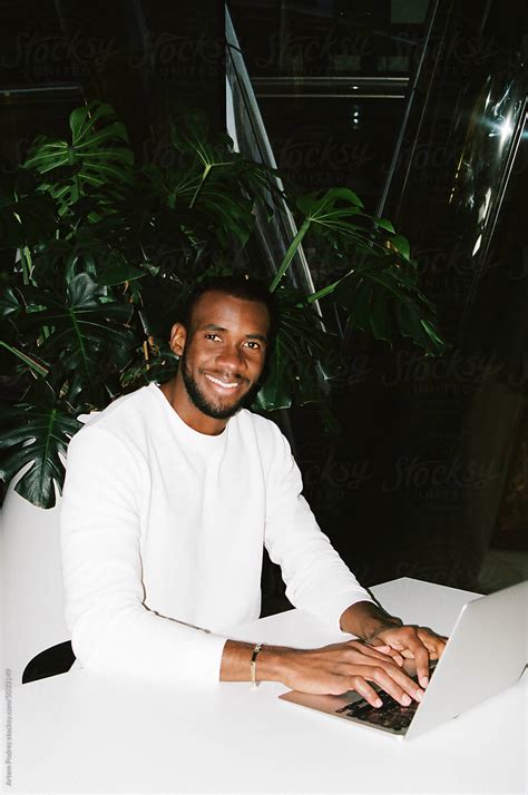 Film Photo Portrait A Black Man Working At Laptop In Office By