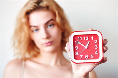 Premium Photo Woman Holds Red Alarm Clock In Her Hand Male Sex Problems Fast Ejaculation Concept