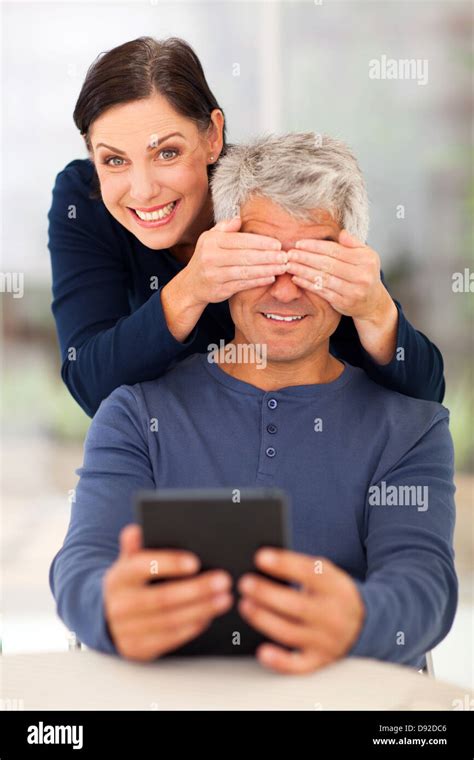 Playful Middle Aged Couple Having Fun At Home Stock Photo Alamy