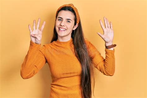 Young Brunette Teenager Wearing Casual Yellow Sweater Showing And
