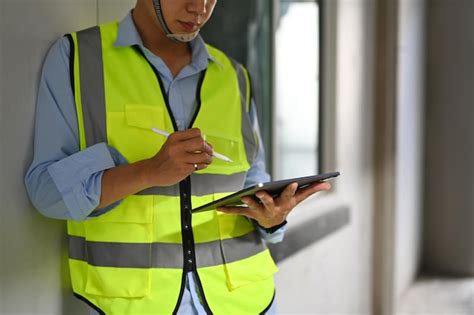Premium Photo Cropped Shot Of Engineer Man In Reflective Jackets Using Digital Tablet