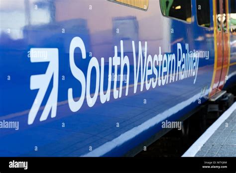 Class 450 Desiro Train In Swt Livery But With South Western Railway Logos Is In The Platform At