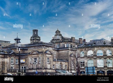 Classic European Architecture Under A Dynamic Sky With Wispy Clouds Showcasing Historic