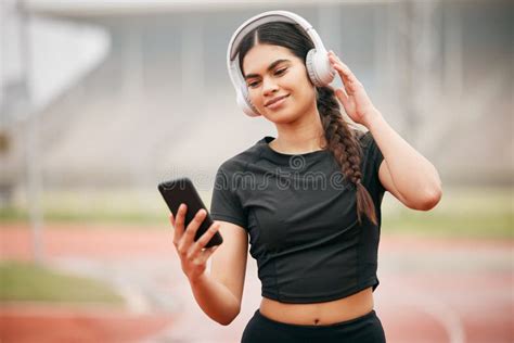 Woman Headphones And Phone For Fitness At Stadium Online And App For Progress Or Workout Music