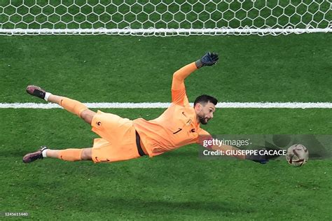 Frances Goalkeeper Hugo Lloris Dives To Save A Shot During The Qatar