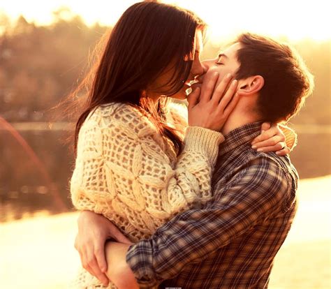 Download Husband And Wife Kissing At Sunset Wallpaper