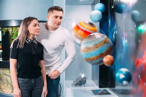 Premium Photo The Couple View The Exposition Of The Planets Of The Solar System In The Museumm