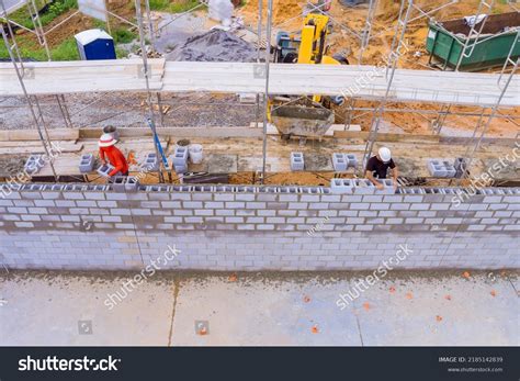 Construction Site Workers On Scaffolding Laying Stock Photo 2185142839 Shutterstock