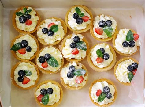 Assorted Berry Tartlets With Whipped Cream Premium Photo