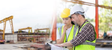 Engineer And Foreman Worker Team With Blueprints Checking Project At The Precast Concrete