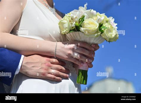 The Newlywed Couple Is Holding A Beautiful Wedding Bouquet Classical