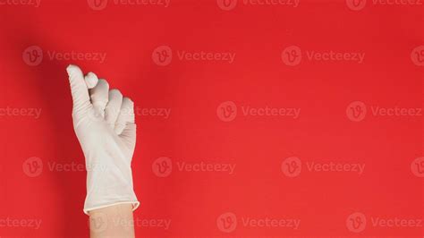 Mini Haert Hand Sign With Gloves In Right Hand On Red Background