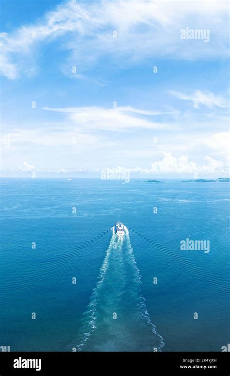 Stern Of Large Cargo Ship Import Export Container Box On The Ocean Sea On Blue Sky Back Ground