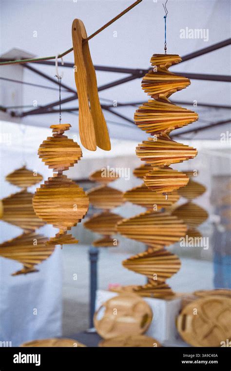 Wooden Multi Layered Hanging Items Designed As Rotating Geometric Structures Creating A Sense
