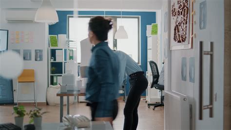 Woman Architect Working On Blueprints Plan To Design Construction Layout With Building Model