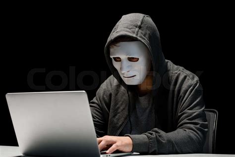 Anonymous Internet Troll In Mask Typing On Laptop Keyboard Isolated On