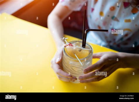 Female Drinking Kamikaze Cocktail Tiki Glass Vodka Triple Sec Lemon