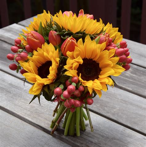 Hand Tied Bouquet Of Sunflowers Tulips And Hypericum Berries