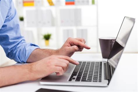 Premium Photo Man Typing At Laptop Keyboard In Office