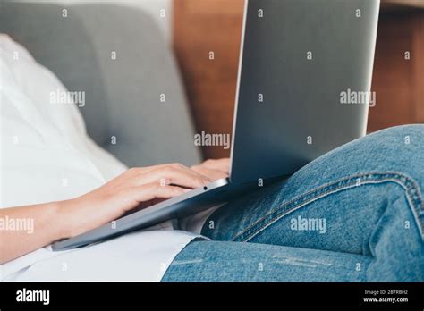 Closeup Image Of Woman Using And Typing On Laptop Keyboard While Sitting With Feeling Relaxed