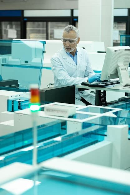 Premium Photo Pleased Mature Man Testing Computer In Lab