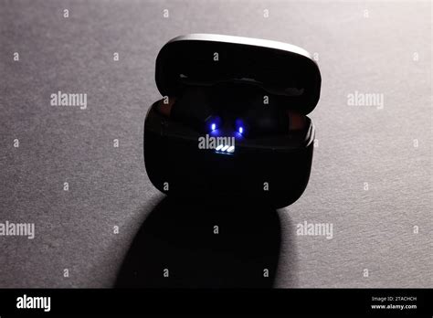 A Studio Shot Of A Pair Of Black Jbl Wireless Bluetooth Earphones Against A Dramatically Lit