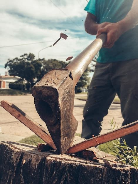 Premium Photo Midsection Of Man Cutting Tree Trunk