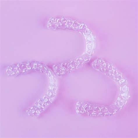 Premium Photo Invisible Dental Teeth Brackets Tooth Aligners On Pink