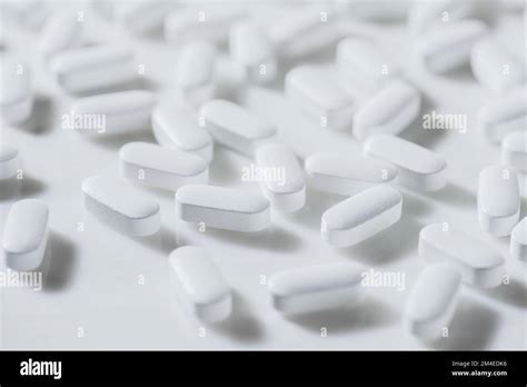 Full Frame White Pills Dropped Against White Marble Backgrounds