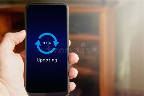 Male Male Hand Holding Mobile Phone Showing Update Interface And Icon With Percentage Progress