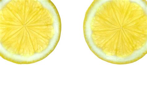 Premium Photo Close Up Of Lemon Slice Against White Background