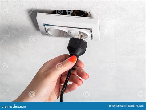The Girl Puts The Electric Plug Into A Broken Socket Risk Of Electric Shock Close Up Stock