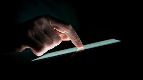 Premium Photo Close Up Silhouette Man Hand Touching A Touch Screen Device On Black