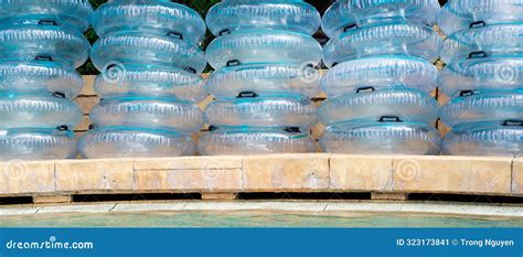 Panorama View Stack Of Clear Floats Near Lazy River With Pool Overflow Drainage Limestone Wall