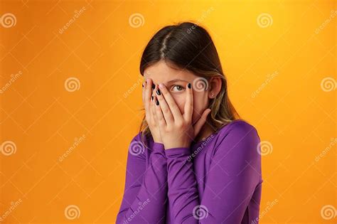 Anxious Teen Girl Looking Scared Or Worried On Yellow Background Stock