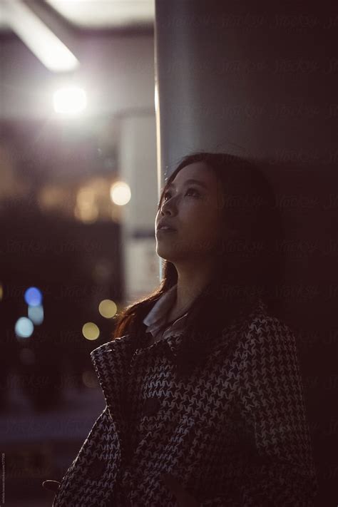 Portrait Of Young Asian Woman Outdoors By Night By Stocksy