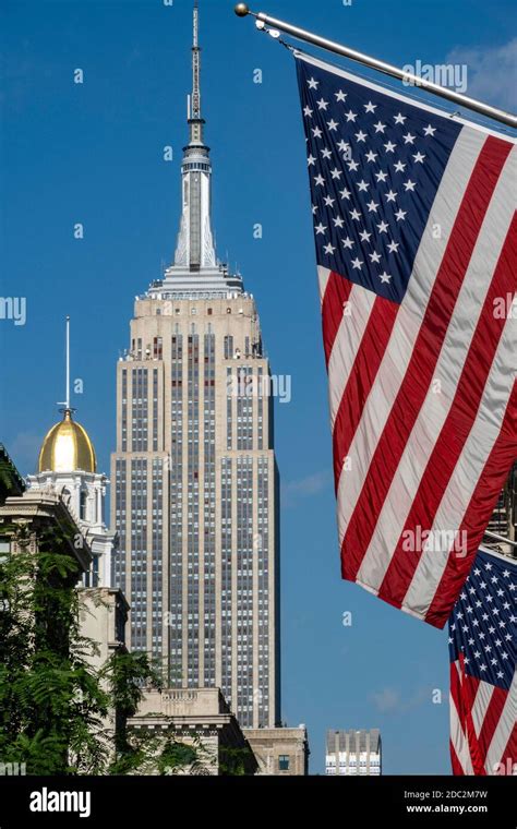 The Iconic Empire State Building Is Viewed With An American Flag On
