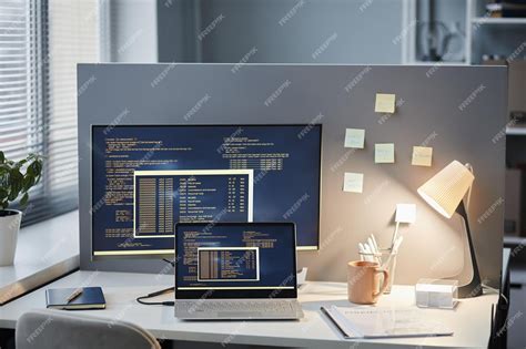 Premium Photo Office Workplace Setting With Code Lines On Computer Screens