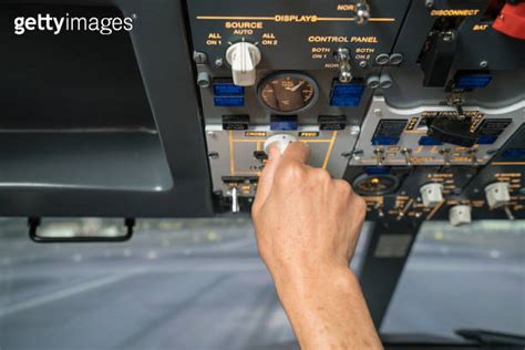 Pilot pushing buttons in the cockpit 이미지 게티이미지뱅크