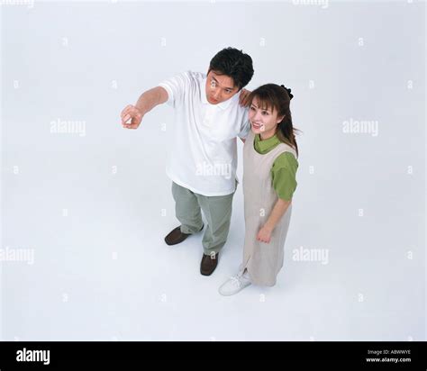 A Man Pointing Out At A Direction While His Wife Looks On Stock Photo Alamy