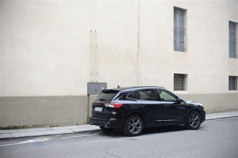 Modern Black Ford Kuga St Line X Parked Beside Beige Wall Highlighting Sporty Lines And