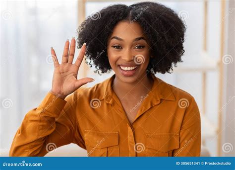 Cheerful Millennial Curly African American Lady Waving Hand Has Video